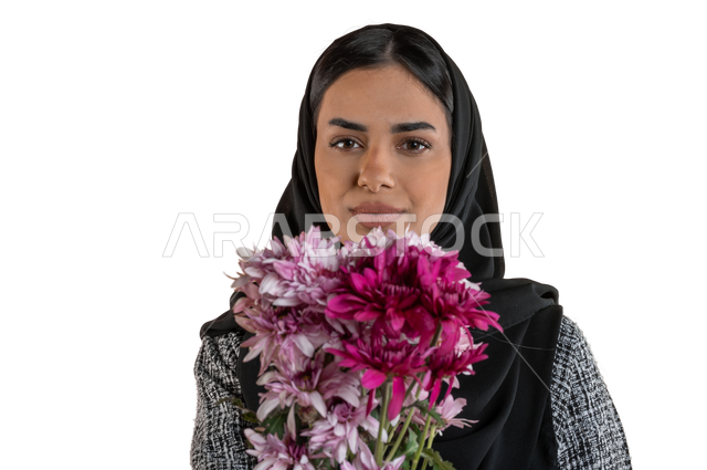 Portrait of a Saudi Arabian Gulf woman holding beautiful roses in her ...