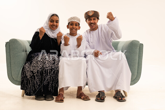 Omani Family in Traditional Clothing Celebrating Victory - Photo