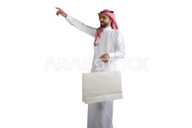 Portrait of a Saudi Arabian man carrying a white bag, a Saudi Gulf ...