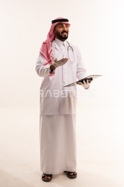 Saudi Male Doctor in Traditional Attire with Clipboard - Photo