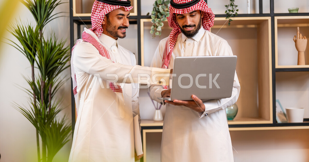 A work discussion between two Saudi Arabian Gulf colleagues, a meeting ...