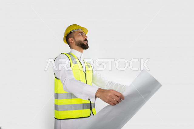 Portrait, Saudi Arabian engineer, skilled engineer in blueprints, Gulf ...