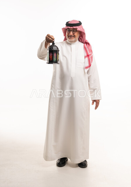 Elderly Saudi Man Holding Ramadan Lantern on White Background - Photo