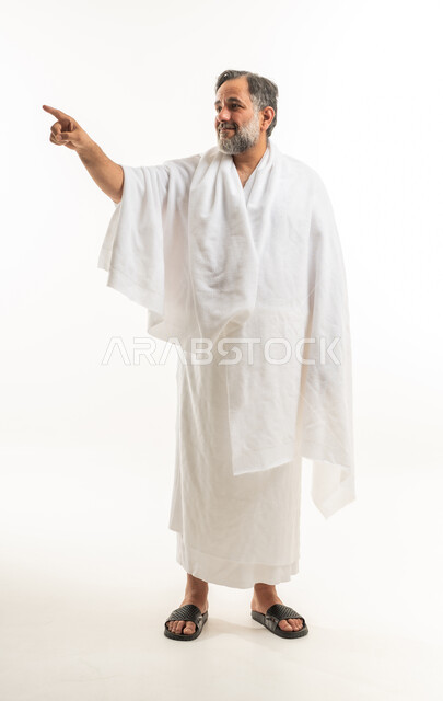 Arab Man in White Ihram Pointing on White Background - Photo