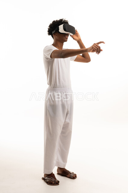 Saudi Man Wearing VR Headset in White Studio Background - Photo