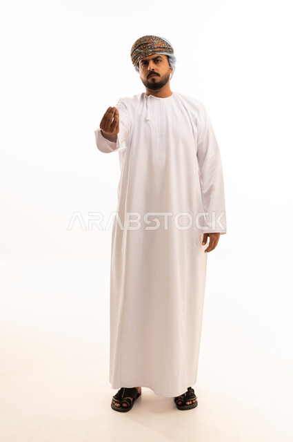 Omani Man in Traditional Dress Making Hand Gesture - Photo