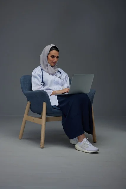 Saudi Female Physician Using Tablet in Studio - Photo