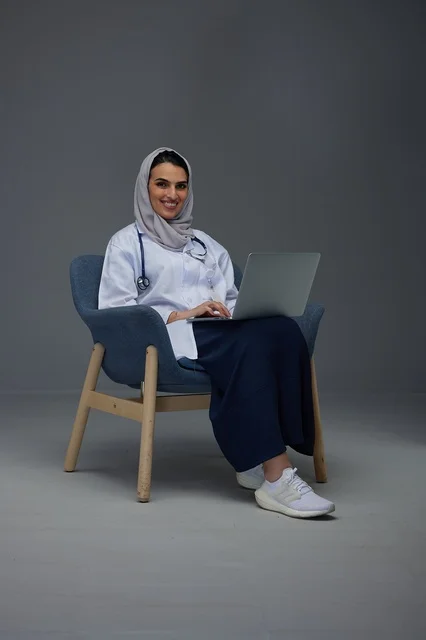 Saudi Female Doctor Using Laptop in Studio - Photo