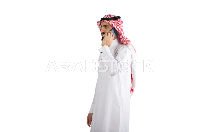 Portrait of a Gulf Saudi man, traditional Saudi wear, mobile phone ...