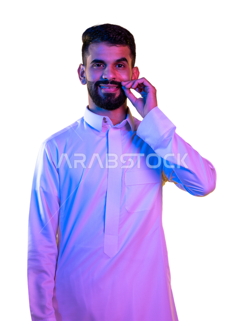Portrait of a Saudi Arabian Gulf youth holding his mustache with ...