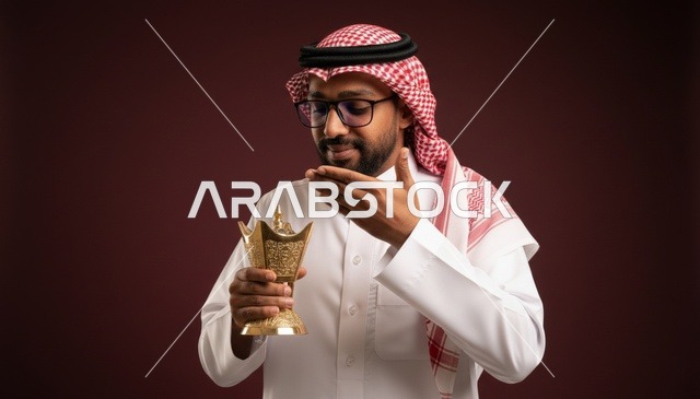 Saudi Man in Traditional Dress with Gold Incense Burner - Photo