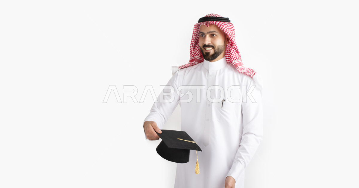 Portrait of a young happy Saudi Arabian graduate throwing a graduation ...