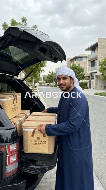 Emirati Man Distributing Eid Meat Boxes in UAE SUV - Photo