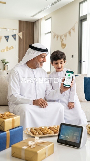Emirati Grandfather Giving Digital Eidiya to Grandson - Photo