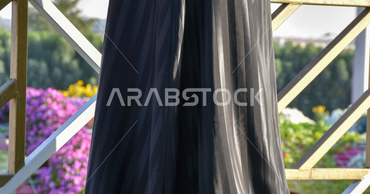 Close-up of a Gulf Arab woman wearing a contemporary abaya and high ...