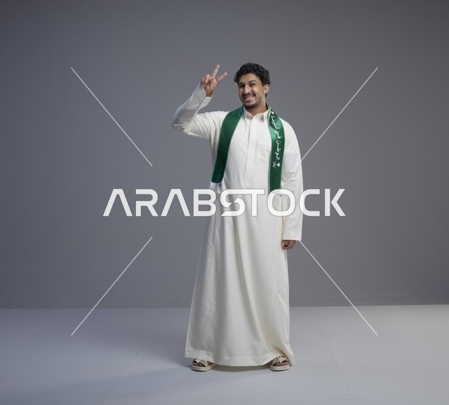 Saudi Man in Thobe with National Scarf Victory Sign - Photo