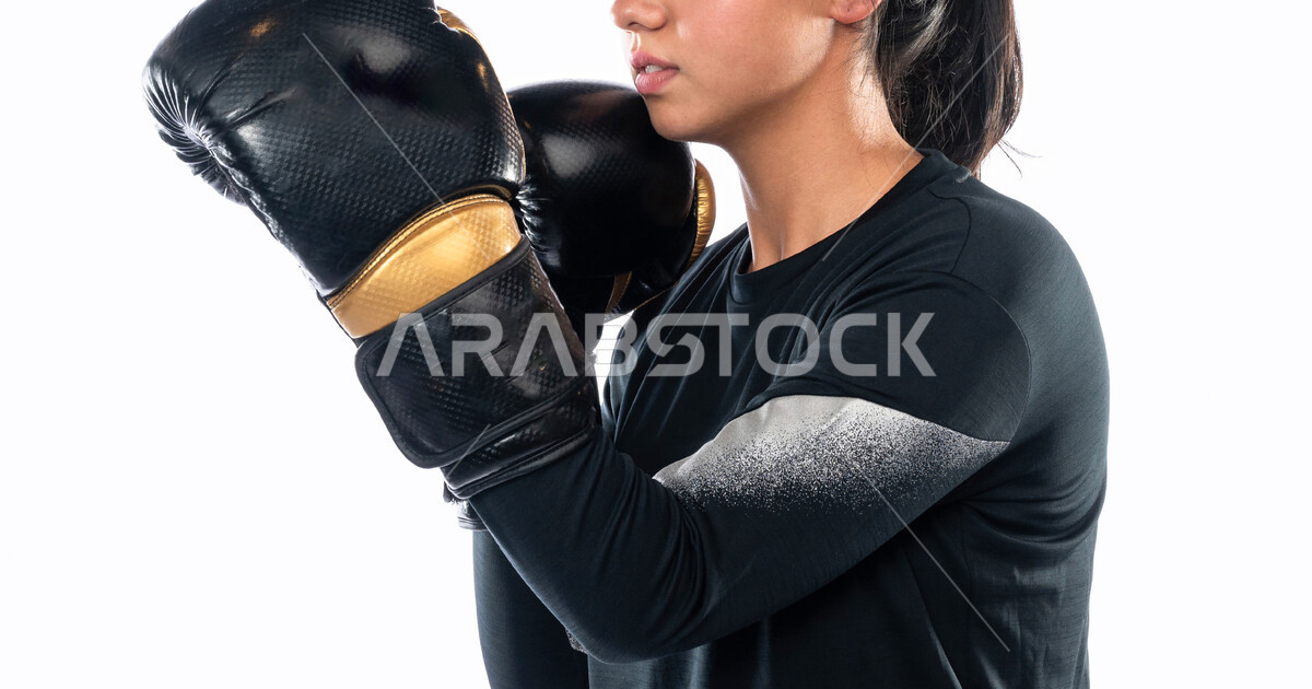 Portrait of a Saudi girl wearing boxing uniforms and boxing gloves ...