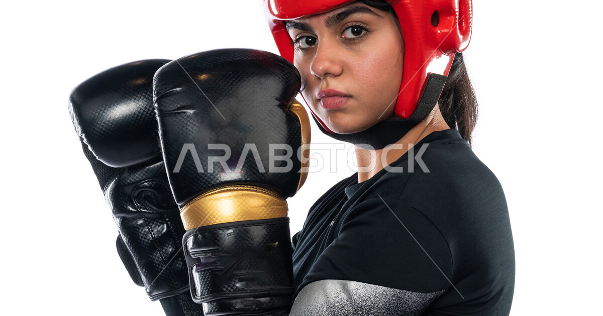 Portrait of a Saudi girl wearing boxing uniform, helmet and boxing ...