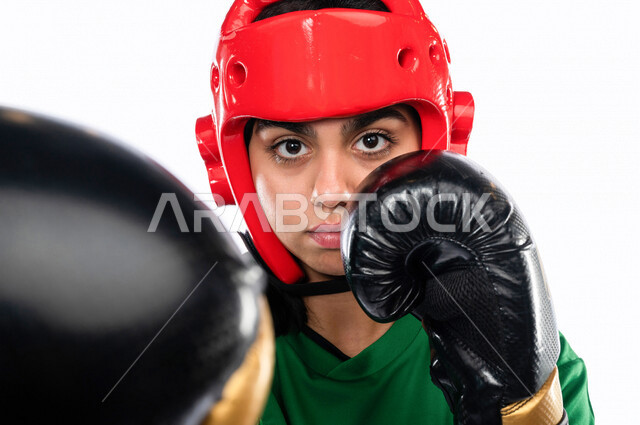 Portrait of a Saudi girl wearing boxing uniform, helmet and boxing ...