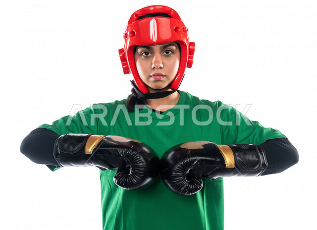 Portrait of a Saudi girl wearing boxing uniform, helmet and boxing ...