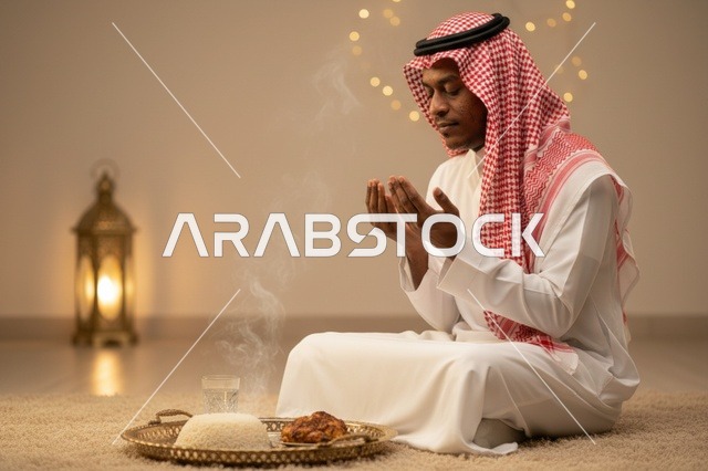 Saudi Man in Thobe Praying Before Ramadan Iftar - Photo
