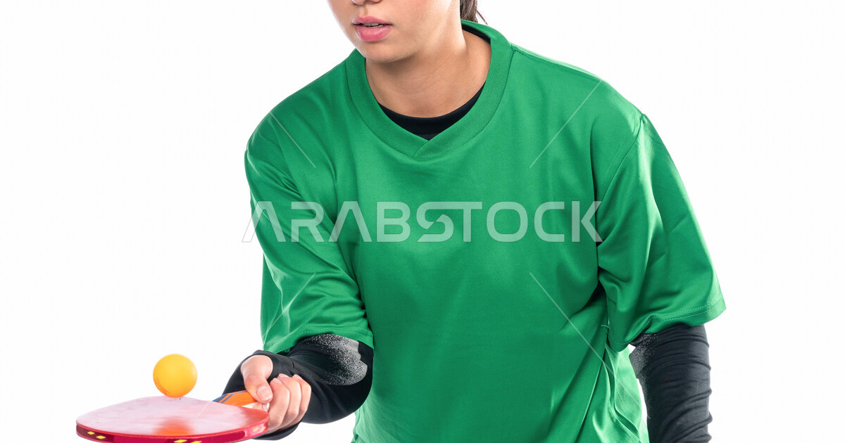 Portrait of a Saudi girl holding a table tennis racket in her hand ...