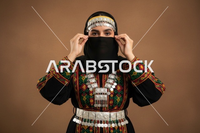 Saudi Woman in Traditional Folk Dress and Silver Jewelry - Photo