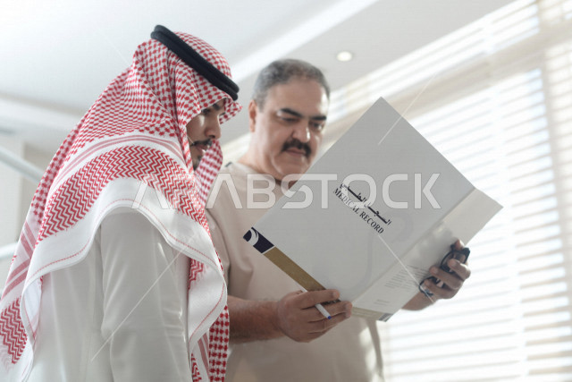 A Saudi Gulf Arab doctor talking with a Saudi Gulf patient, following ...