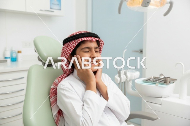 Saudi Boy with Toothache in Dental Clinic Chair - Photo