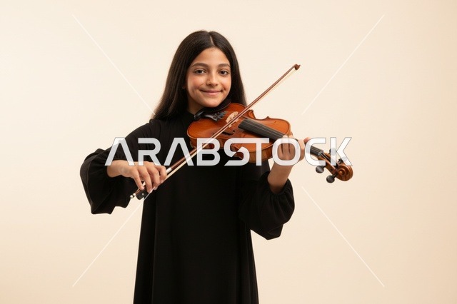 Young Saudi Girl Playing Violin in Studio - Photo