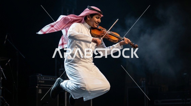 Saudi Musician Playing Violin While Jumping on Stage - Photo
