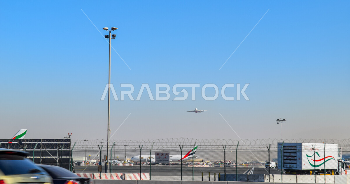 Picture of an Emirates plane flying over Dubai International Airport ...