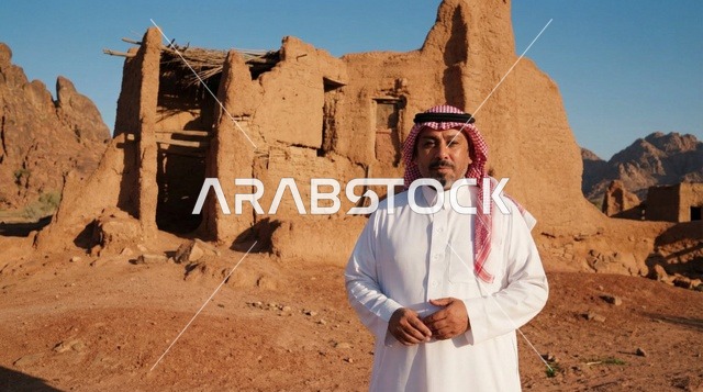 Saudi Man in Traditional Dress at Ancient Mud Ruins - Photo
