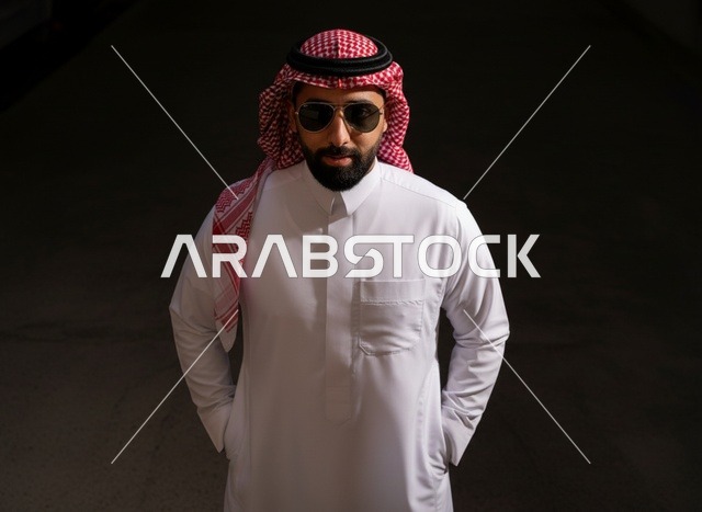 Saudi Man in Traditional Thobe and Sunglasses Portrait - Photo