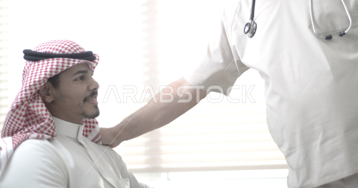 A Saudi Arabian Gulf doctor wearing a stethoscope and placing his hand ...