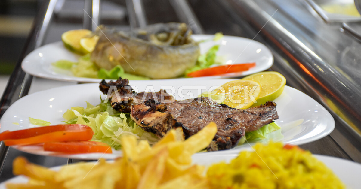 A close-up of delicious healthy food dishes, a plate of mixed meat, an ...