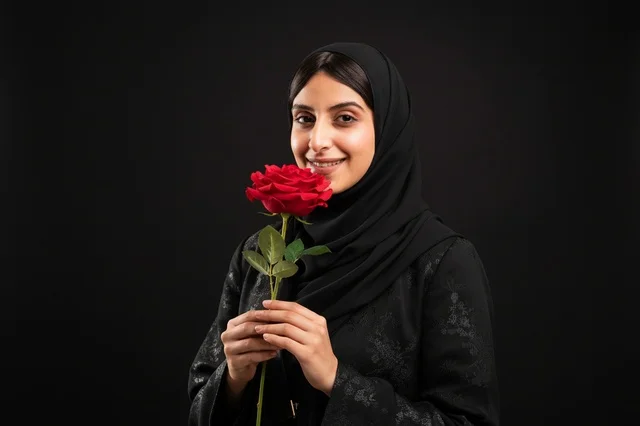 Arab Woman in Abaya Blowing Golden Dust Particles - Photo