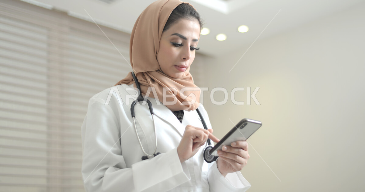 A Saudi Arabian Gulf doctor wearing a medical coat and a stethoscope ...