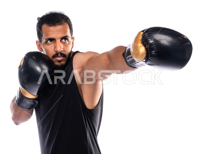 Portrait of a Saudi Arabian Gulf man wearing boxing gloves, practicing ...