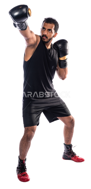 Portrait of a Saudi Arabian Gulf man wearing boxing gloves, practicing ...