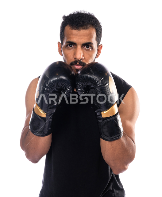 Portrait of a Saudi Arabian Gulf man wearing boxing gloves, practicing ...