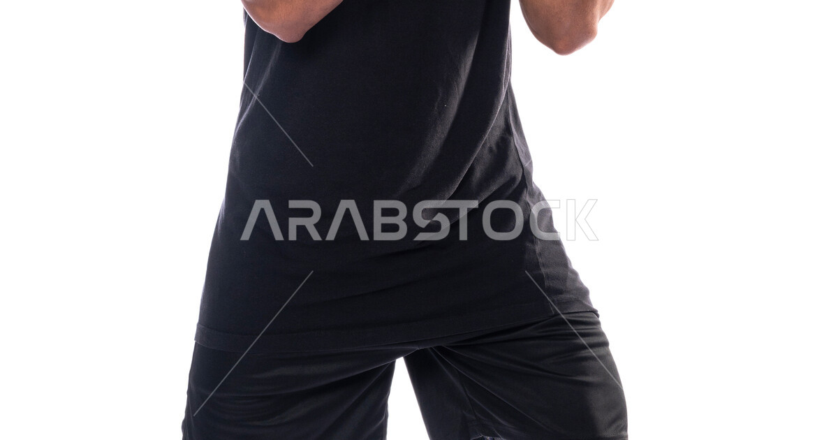 Portrait of a Saudi Arabian Gulf man wearing boxing gloves, practicing ...