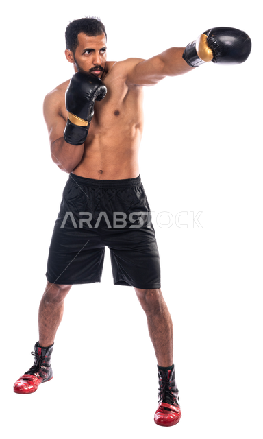 Portrait of a Saudi Arabian Gulf man wearing boxing gloves, practicing ...