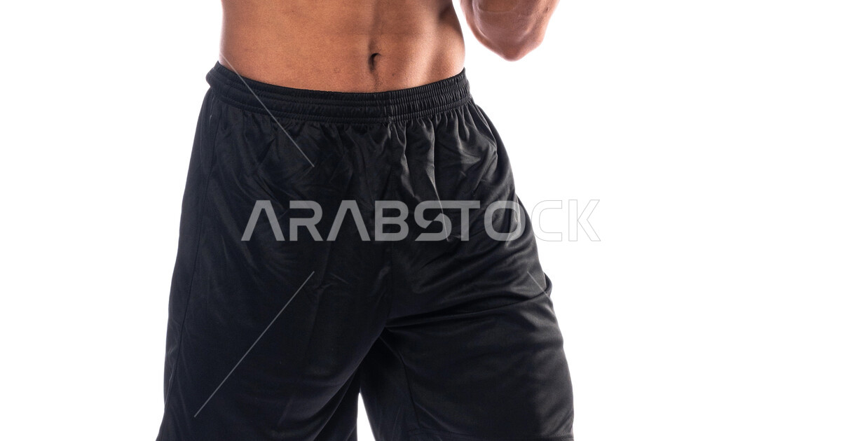 Portrait of a Saudi Arabian Gulf man wearing boxing gloves, practicing ...