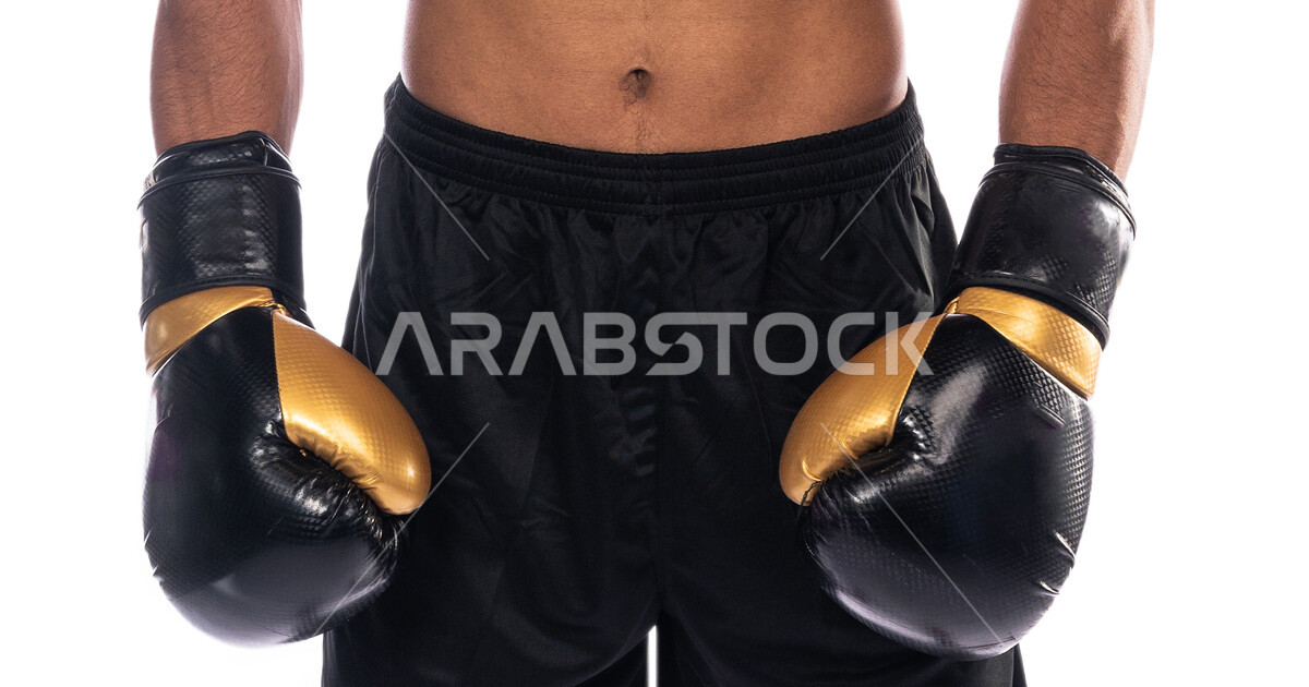 Portrait of a Saudi Arabian Gulf man wearing boxing gloves, practicing ...