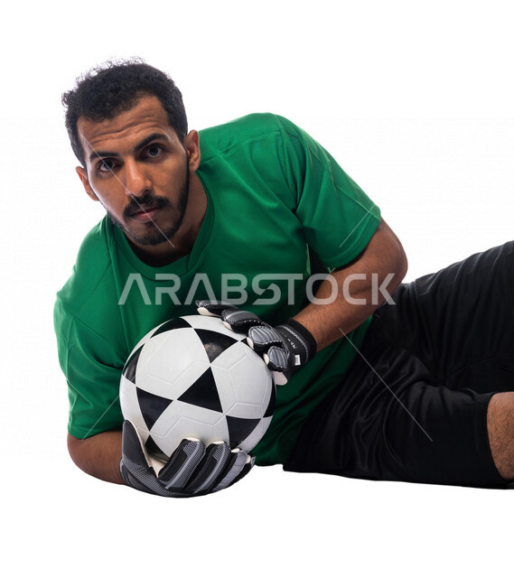 Portrait of a Saudi Arabian Gulf man wearing the football team uniform ...