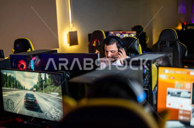 A group of Saudi Arabian Gulf players wearing a headset and playing ...