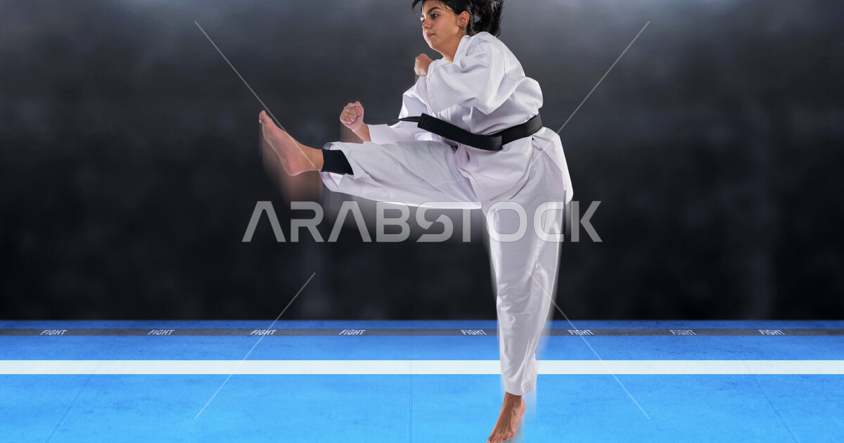 A Saudi Arab girl, wearing a karate uniform with a black belt inside ...