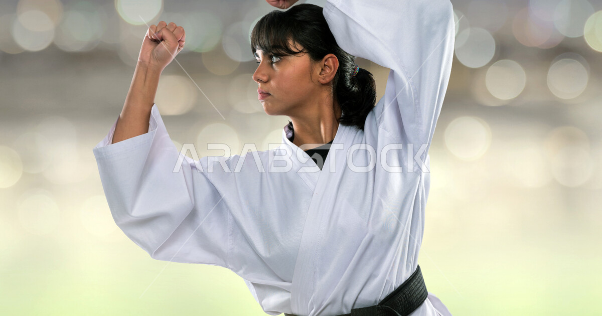 Saudi Arab girl, wearing a karate uniform with a black belt with a ...