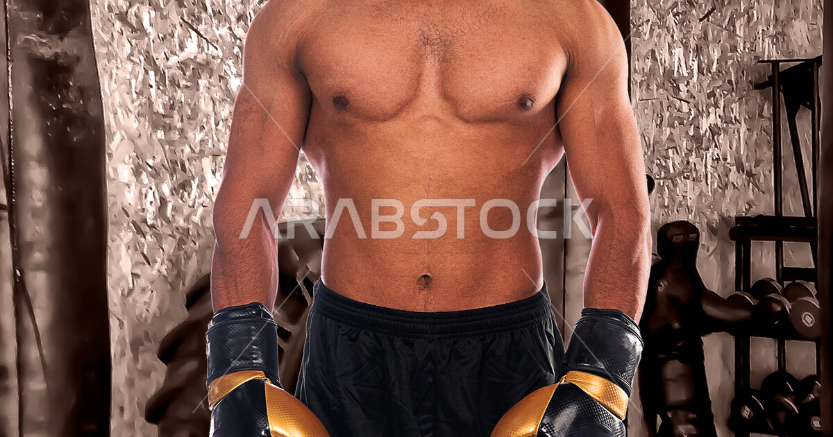 A young Arab Gulf, a Saudi Gulf, wearing boxing costume and boxing ...